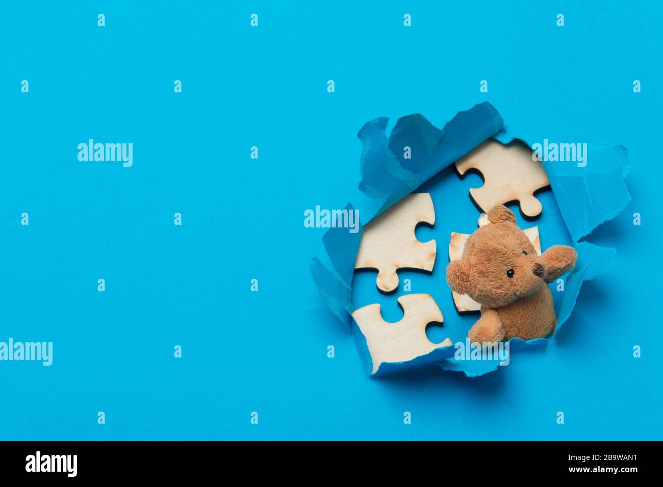 Teddy Bear and wooden Puzzle In Paper cut hole. World Autism Awareness ...