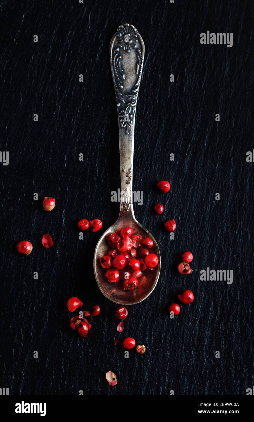 Pink peppers in spoon, top view Stock Photo - Alamy