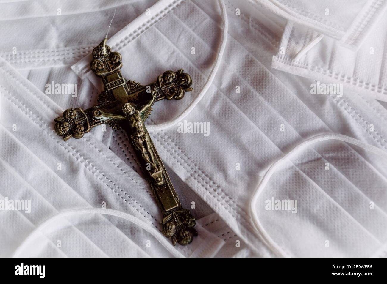 Metal big cross on the white medical face masks Stock Photo - Alamy