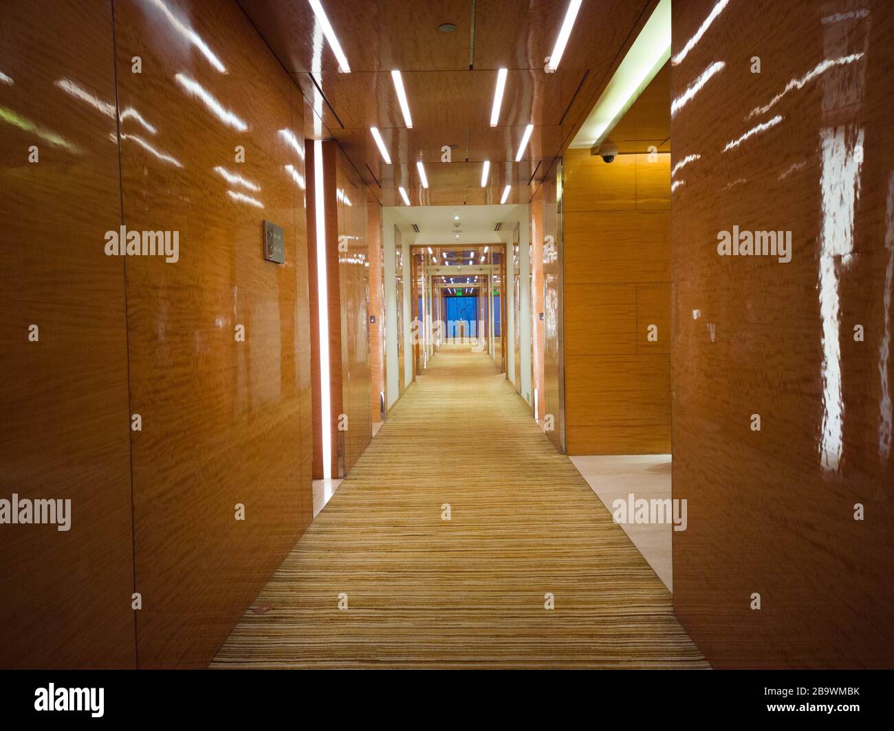 Long beautiful wooden corridor with carpeted floor Stock Photo - Alamy