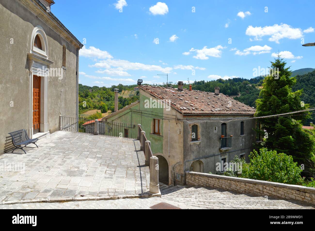 A narrow street between the old houses of Sepino, a medieval village in ...