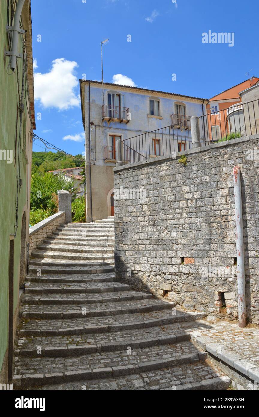 A narrow street between the old houses of Sepino, a medieval village in ...