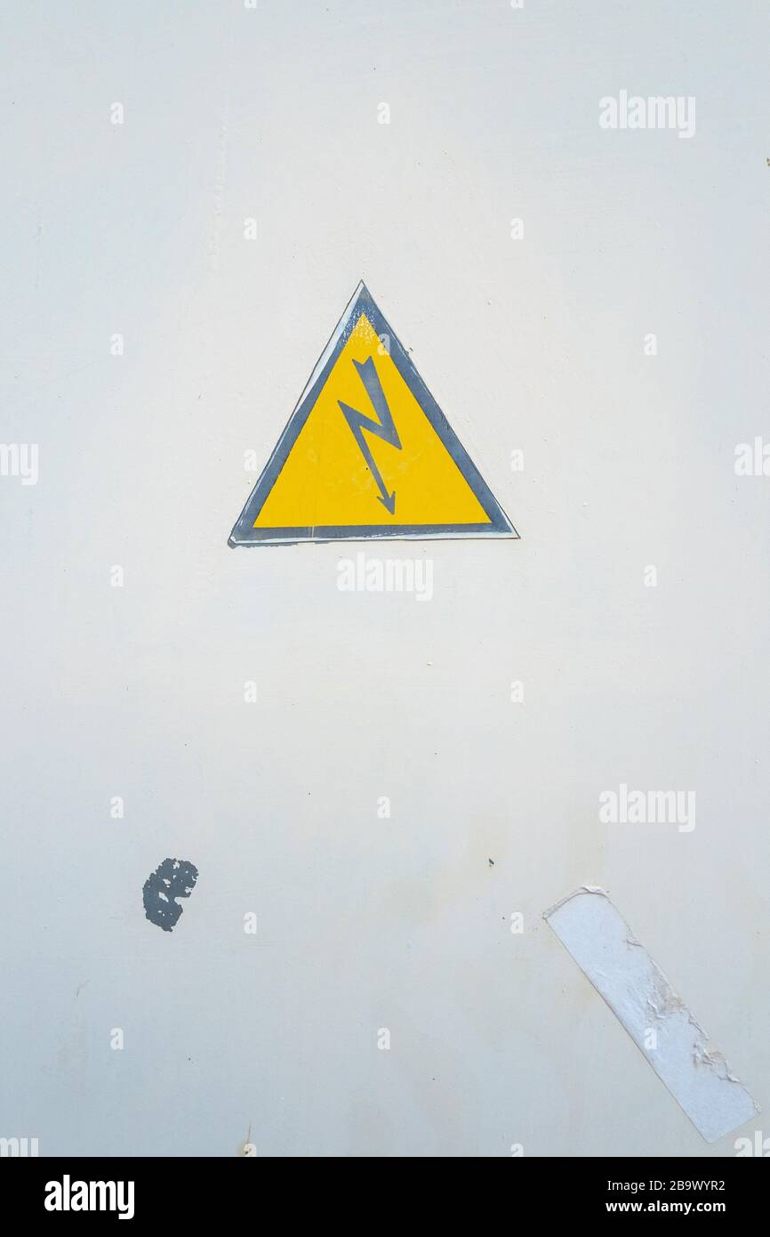 Weathered shock hazard sign on a metal door Stock Photo - Alamy