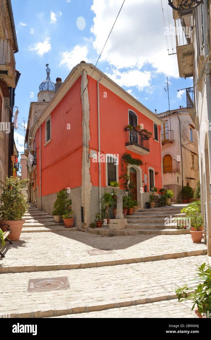 A narrow street between the old houses of Sepino, a medieval village in ...