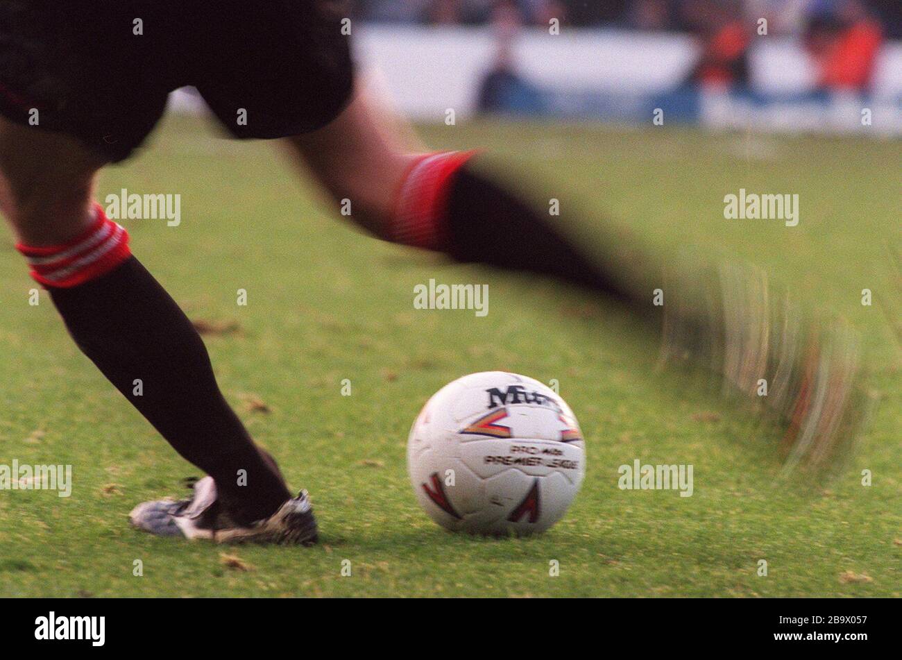 A FOOTBALLER KICKING A MITRE BALL Stock Photo - Alamy