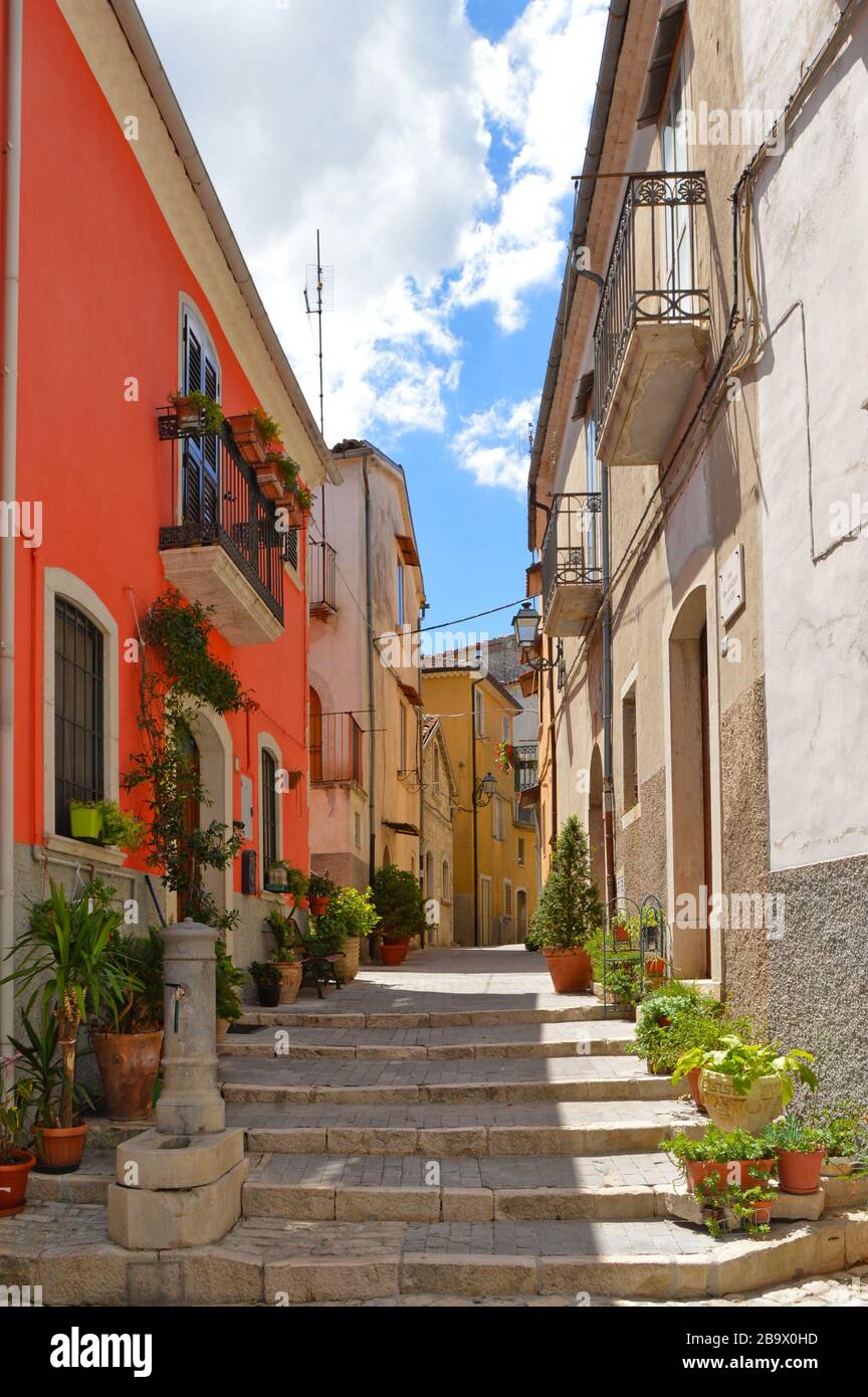A narrow street between the old houses of Sepino, a medieval village in ...