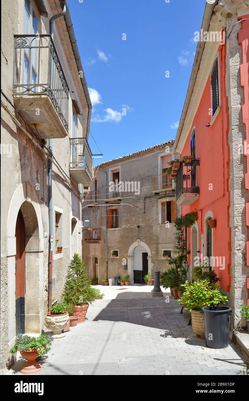 A narrow street between the old houses of Sepino, a medieval village in ...
