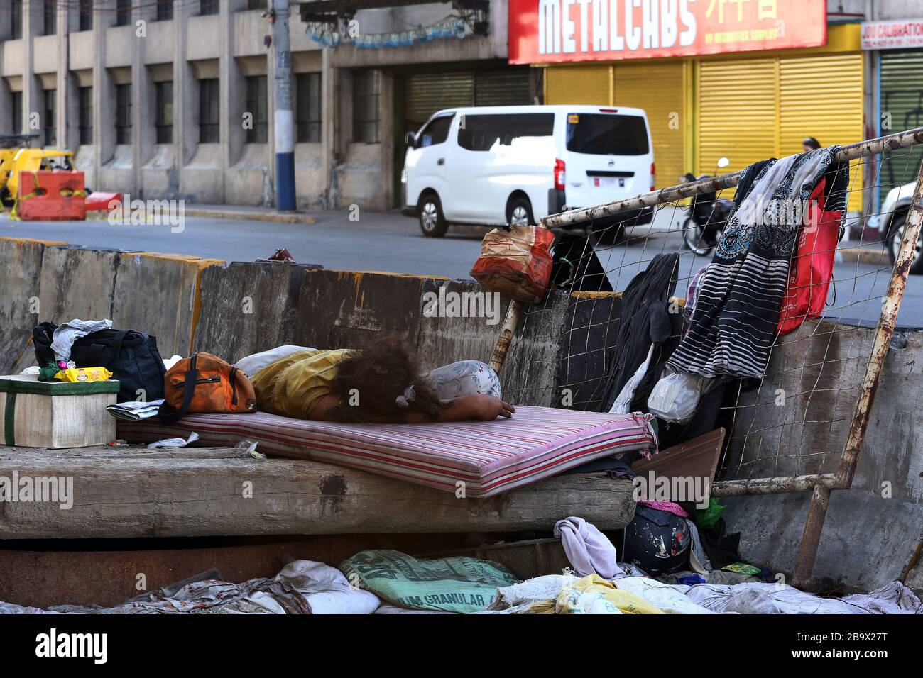 Manila, Philippines. 25th Mar, 2020. A homeless man sleeps on the ...