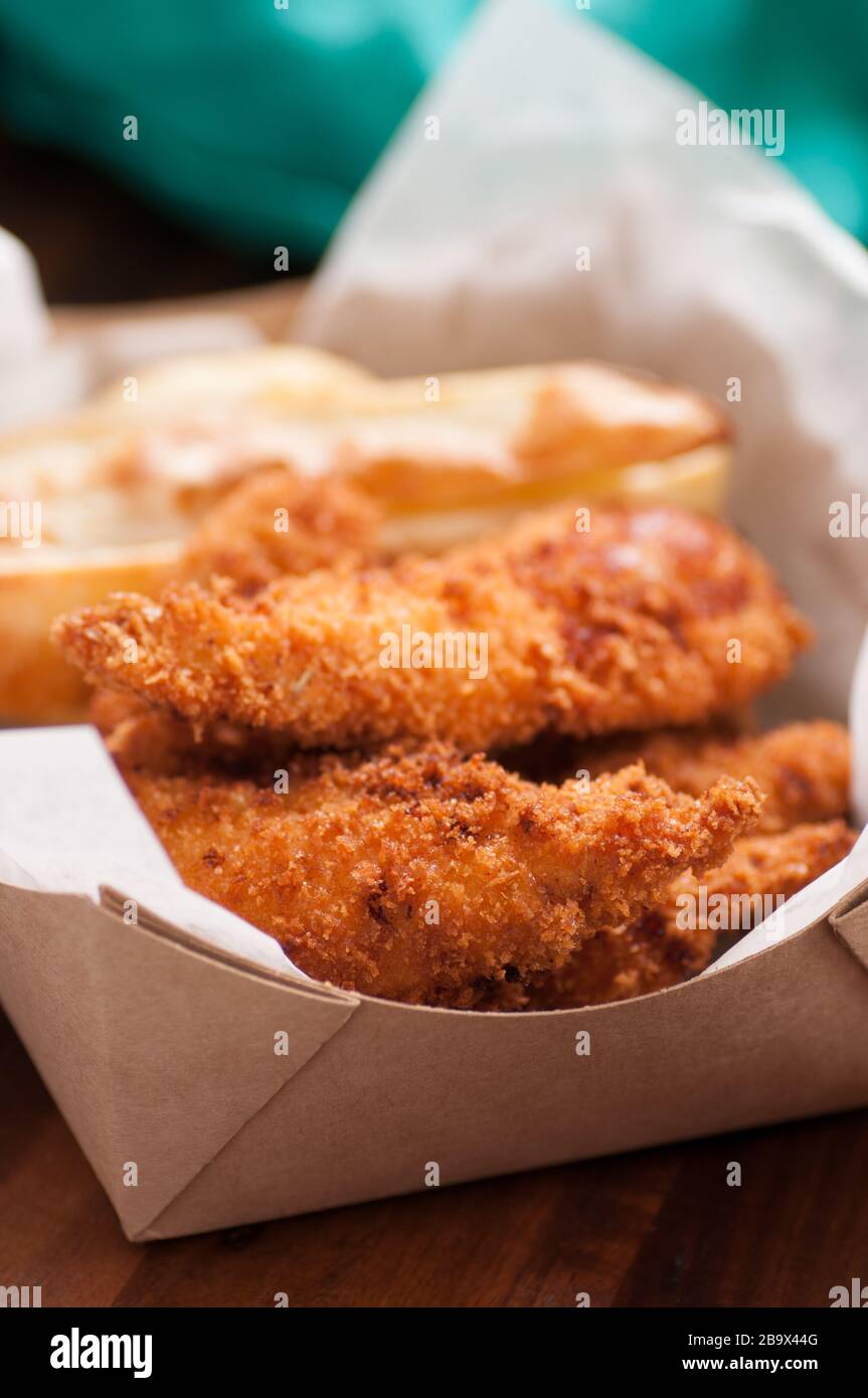 A chicken strips and fries in a take out container Stock Photo - Alamy