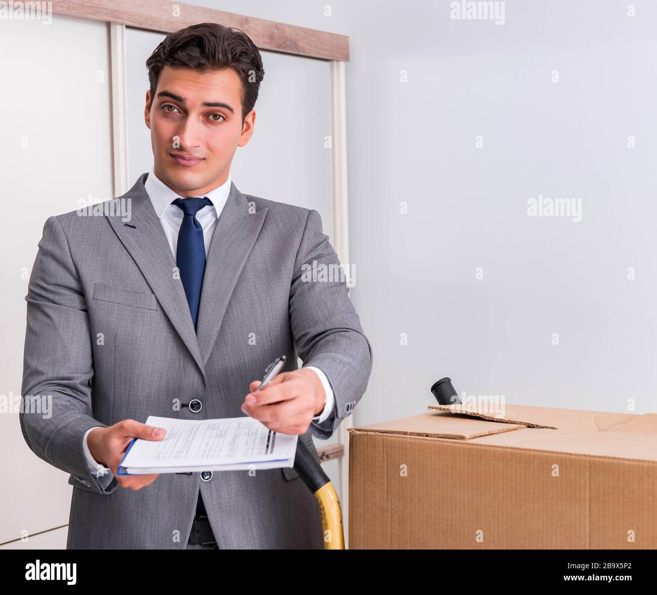 The man signing for the delivery of boxes Stock Photo - Alamy