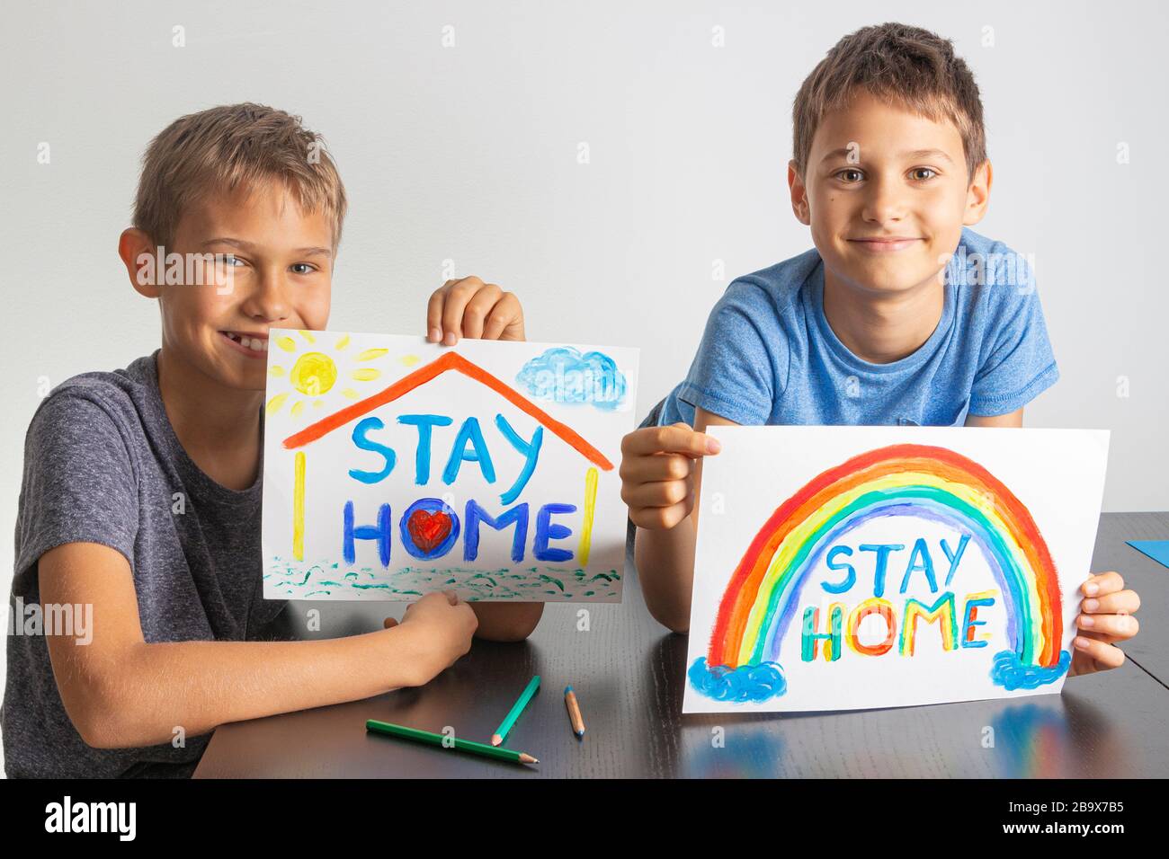 Children holding drawing pictures with words Stay at home. Social media ...