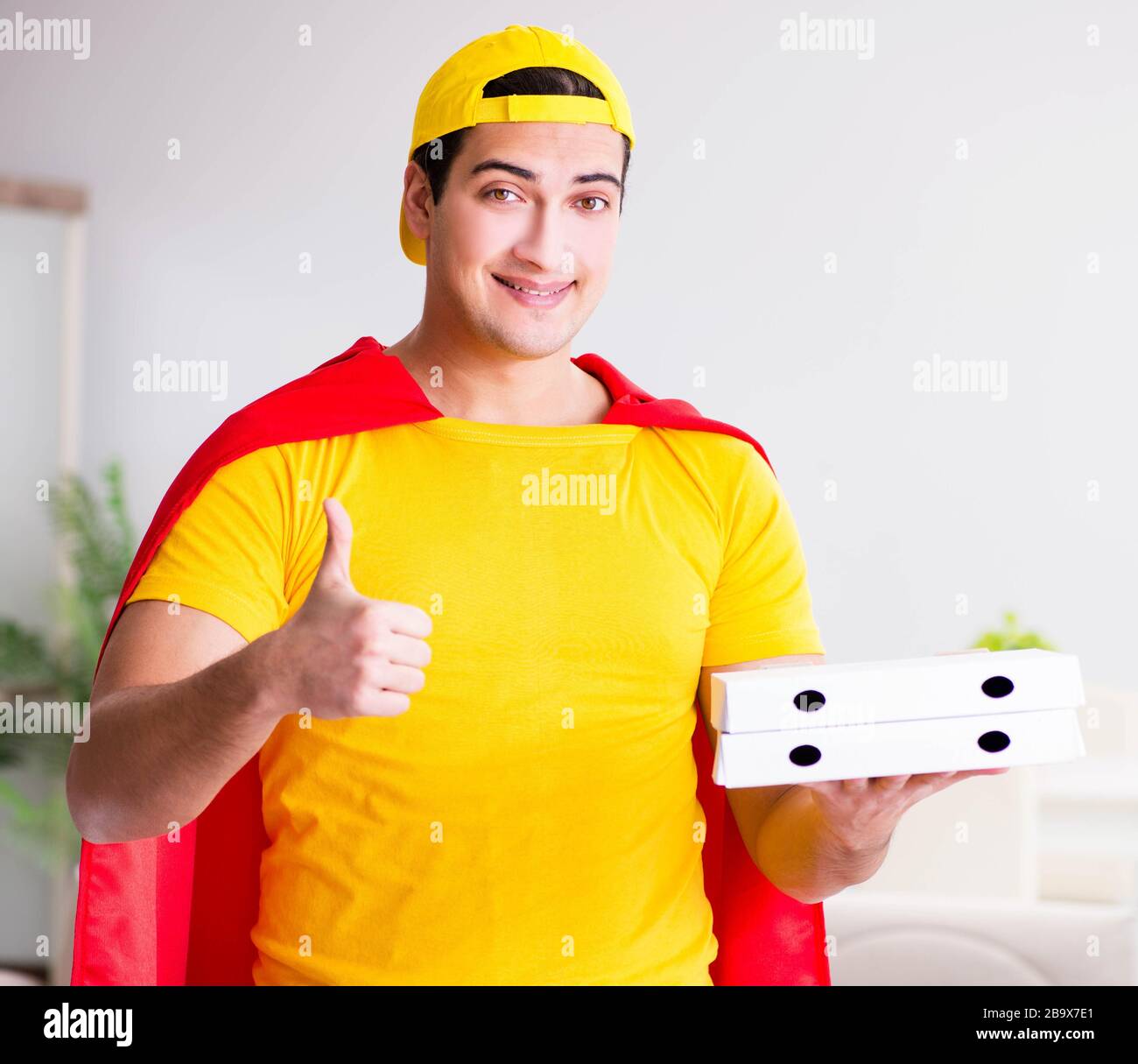 The superhero pizza delivery guy with red cover Stock Photo - Alamy