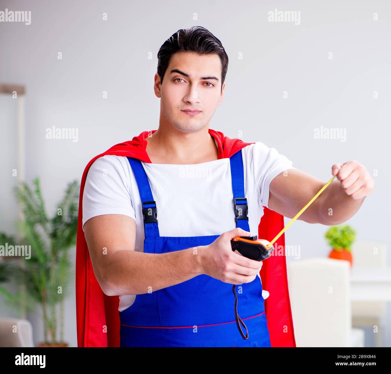 The superhero repairman with tools in repair concept Stock Photo - Alamy