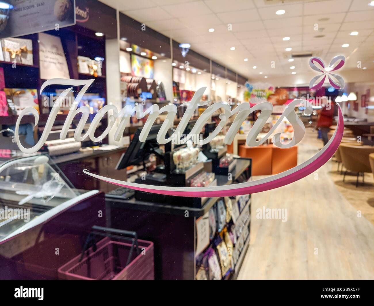UK, March 2020: Thorntons chocolate logo on store entrance shop front ...