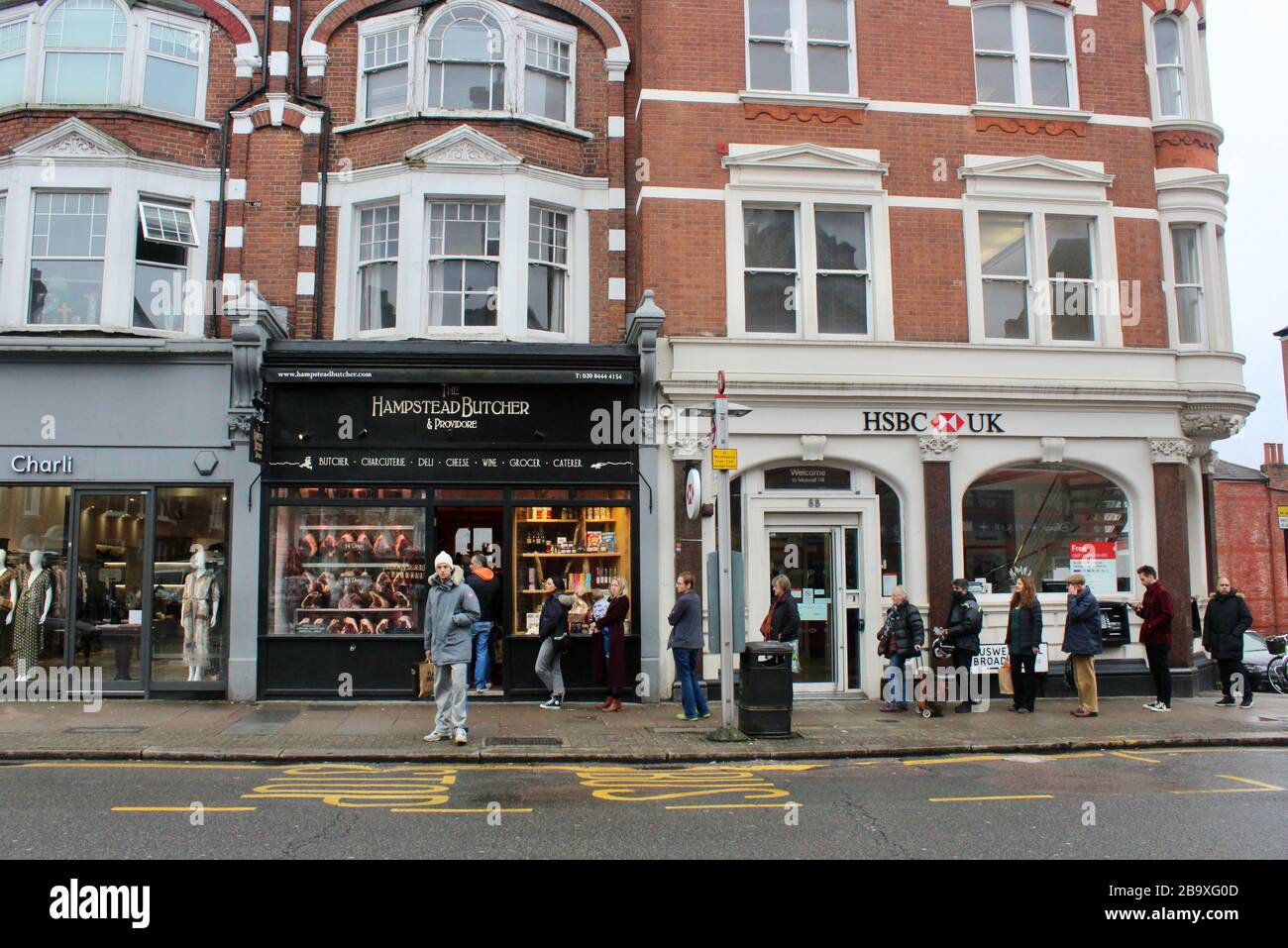 a queue outside hampstead butcher in muswell hill during corona virus ...