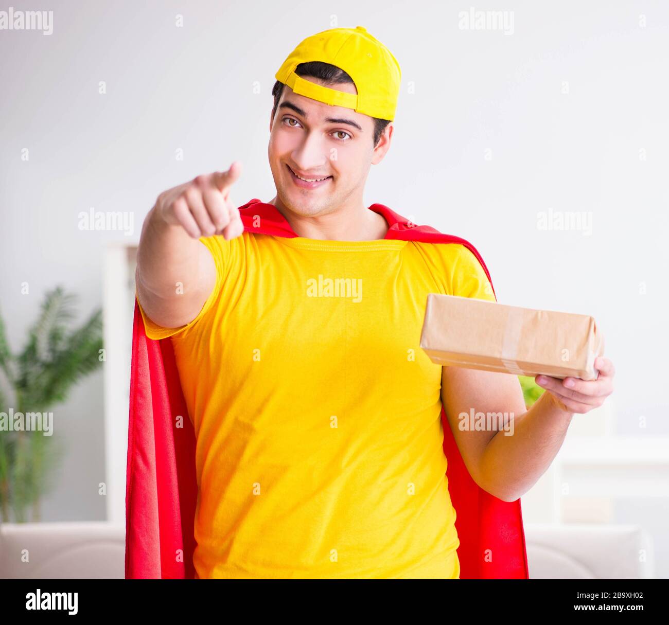 The superhero delivery guy with box Stock Photo - Alamy