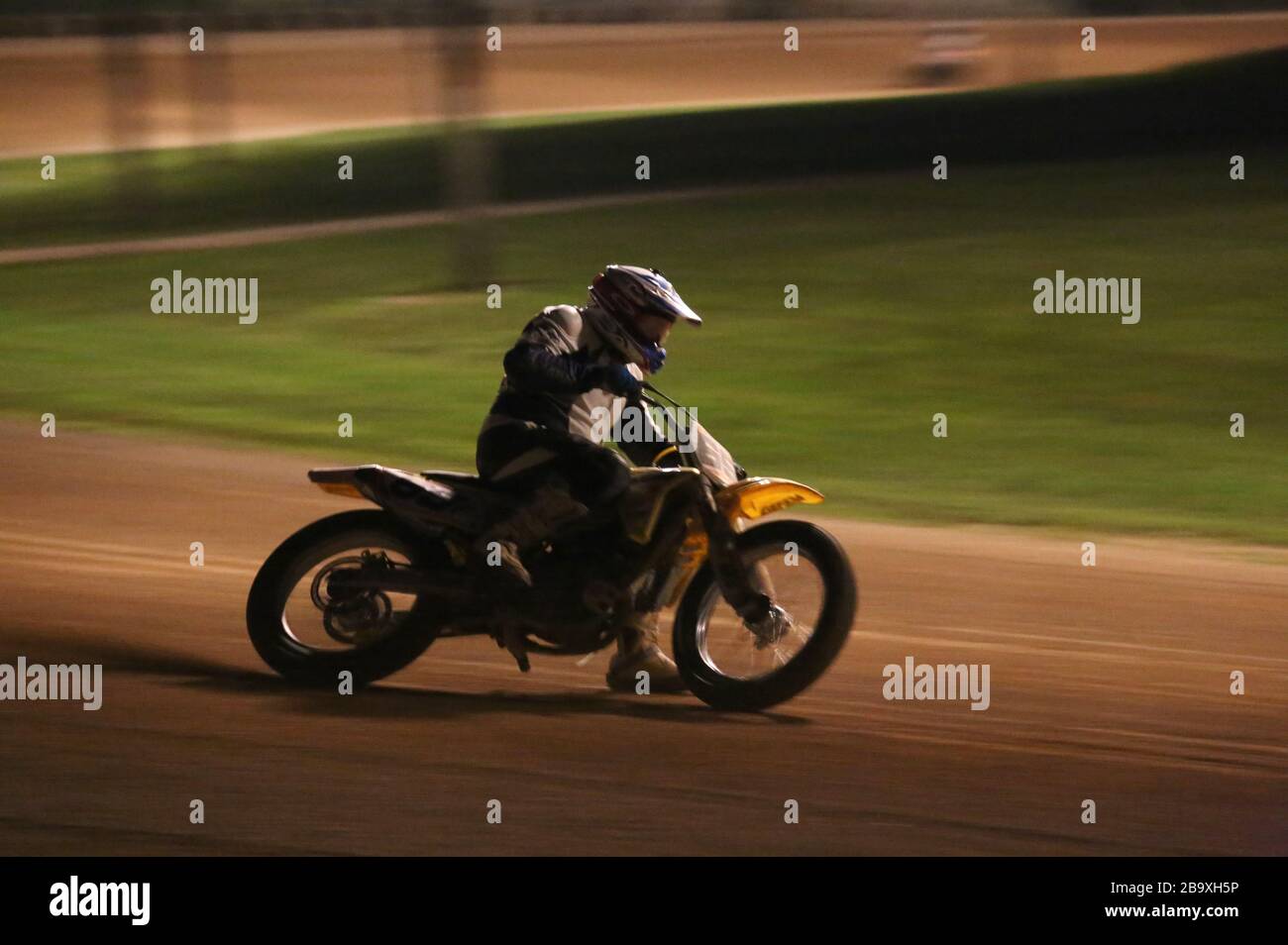 Motorcycle riding the curved track Stock Photo - Alamy