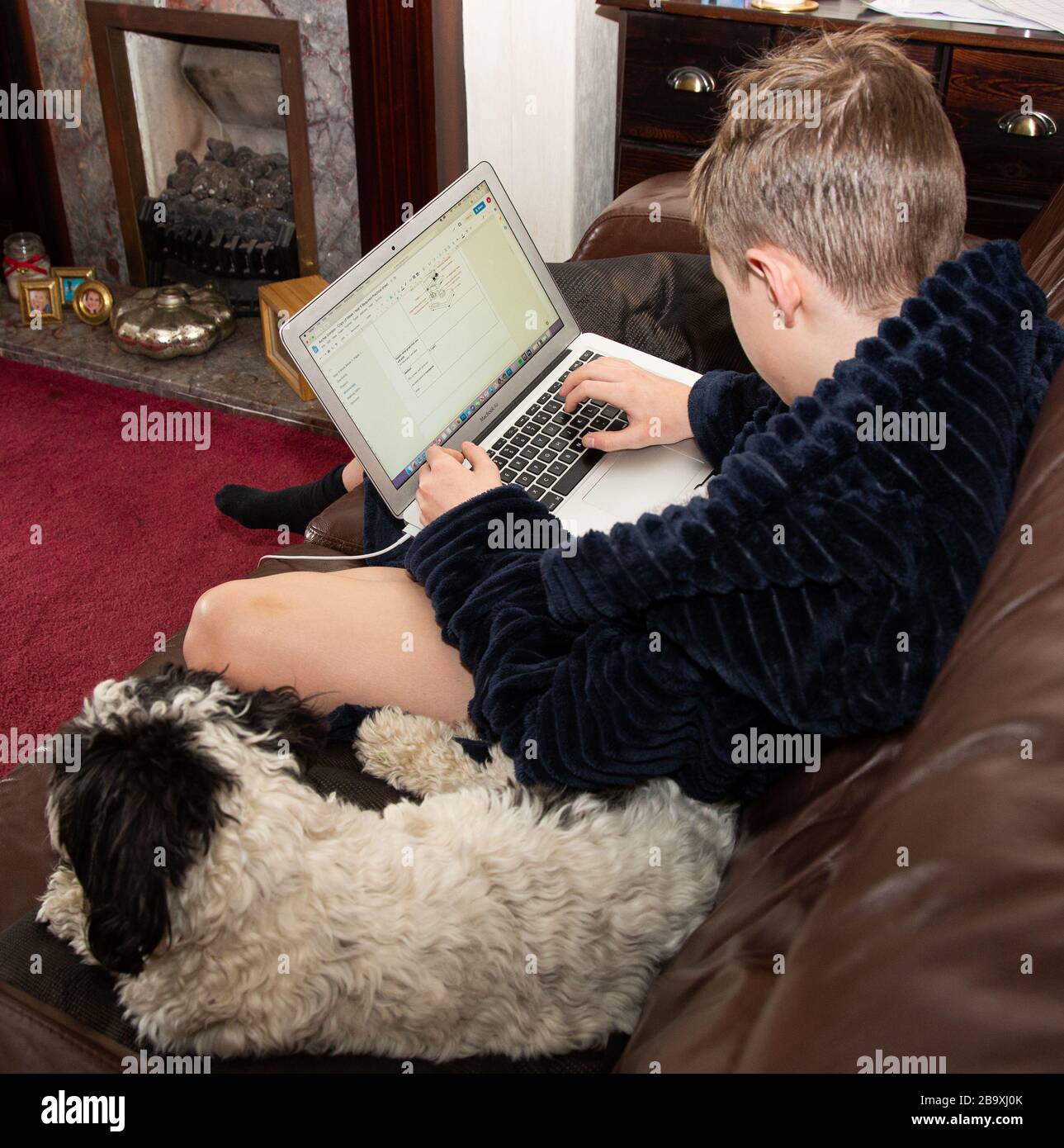 Boy does school work in pjs hi-res stock photography and images - Alamy