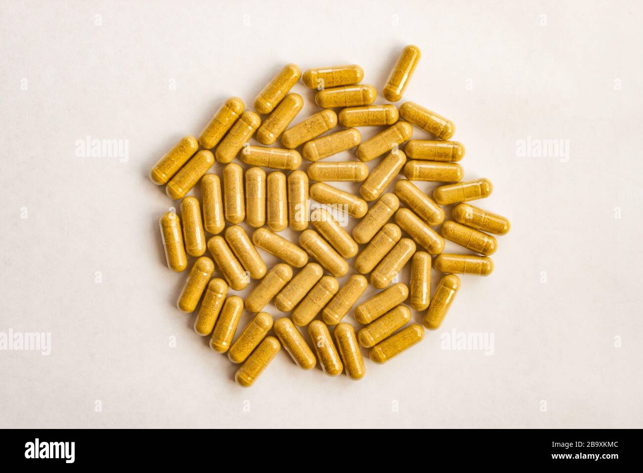 Yellow color pills capsules on white background Stock Photo - Alamy