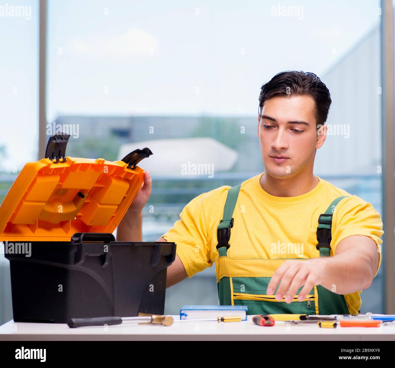 The construction worker sitting at the desk Stock Photo - Alamy