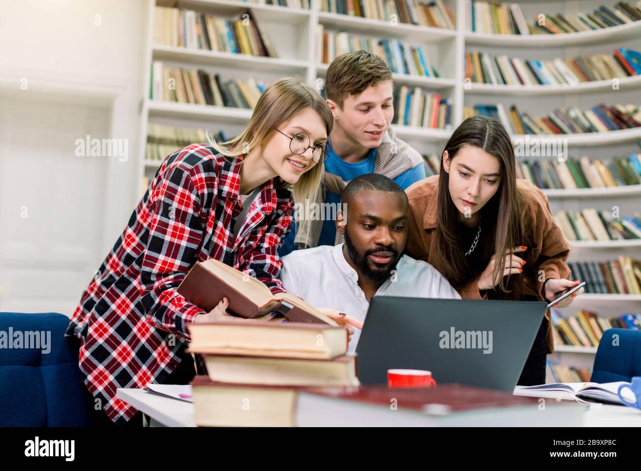 (four in library) studying and reading hi-res stock photography and ...