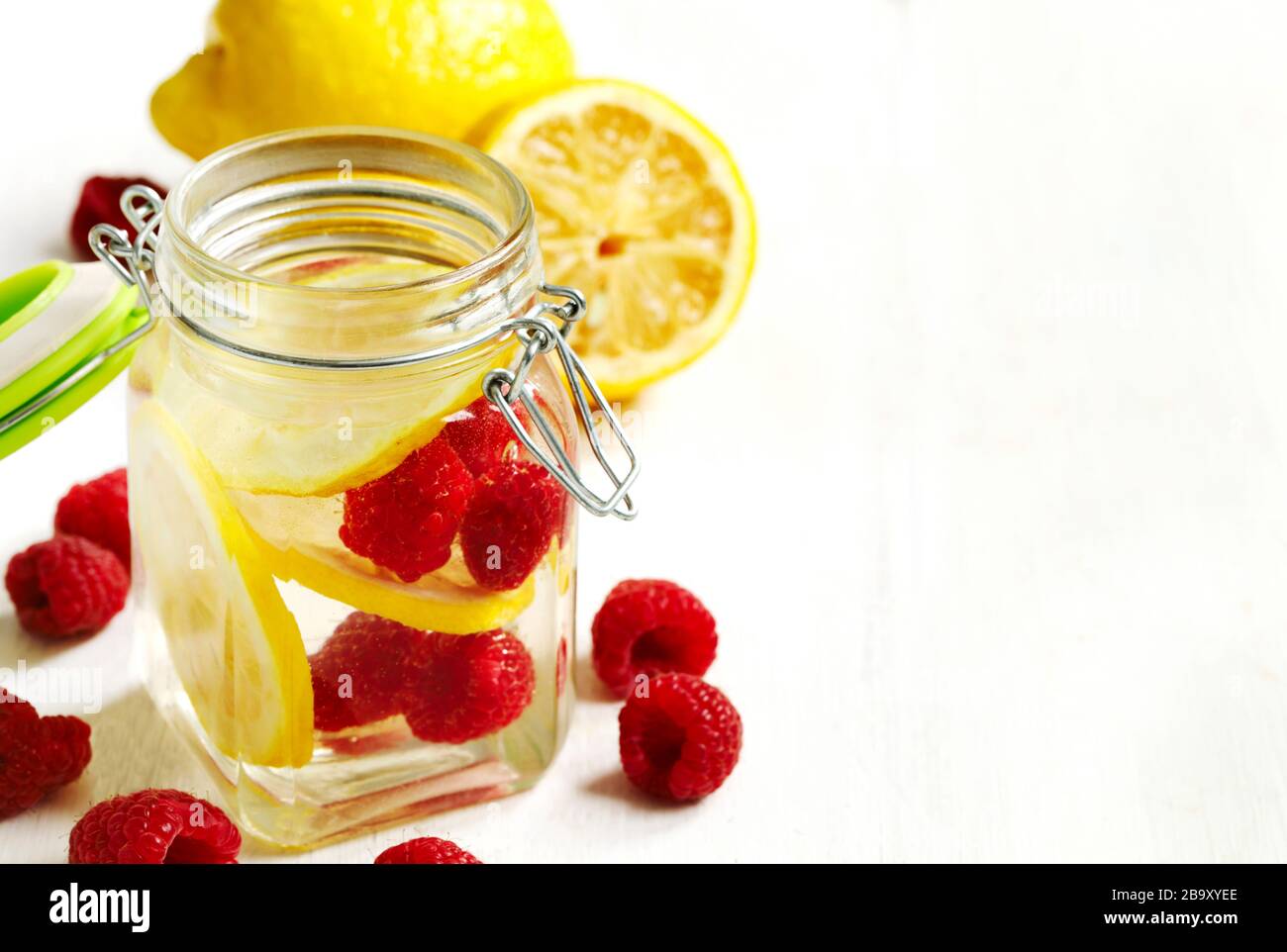Healthy Spa Water with raspberry and lemon on wooden background with ...