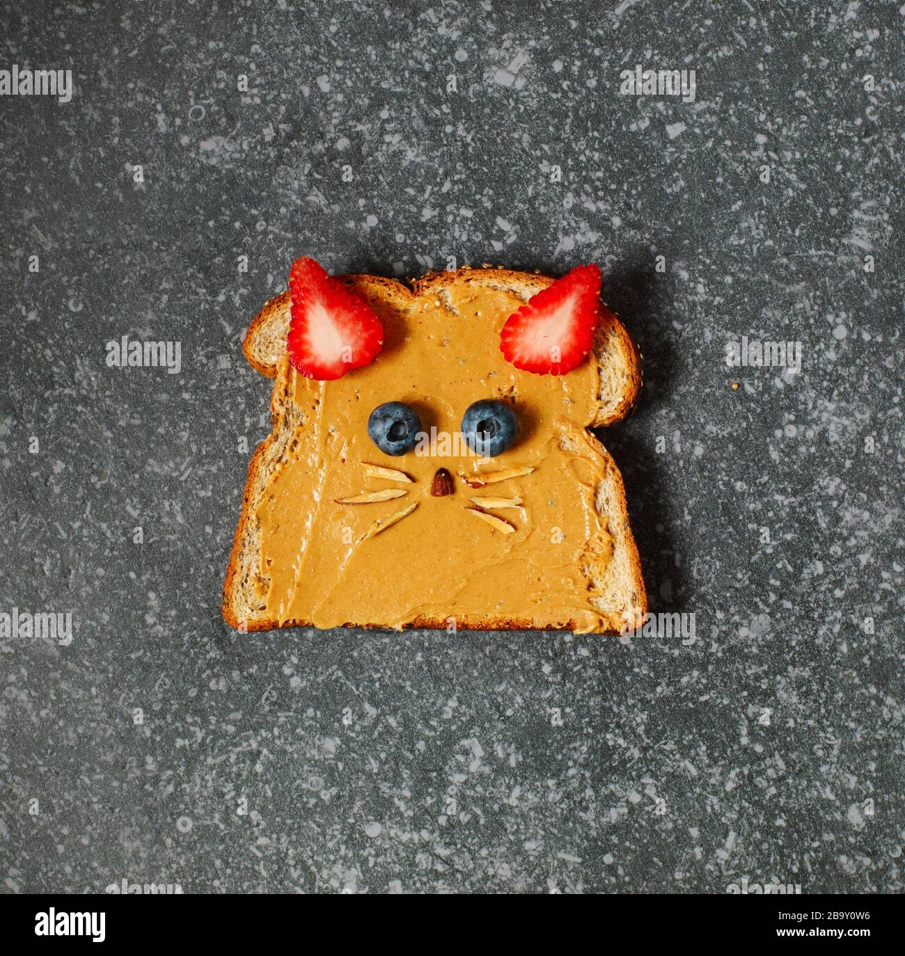 Funny animal face toast with nut spread, strawberry and blueberry Stock ...