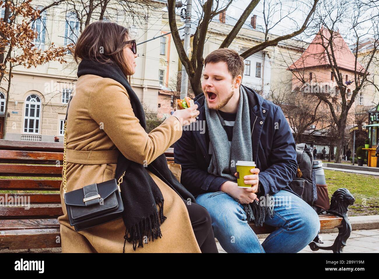 Woman eating burger bench hi-res stock photography and images - Alamy