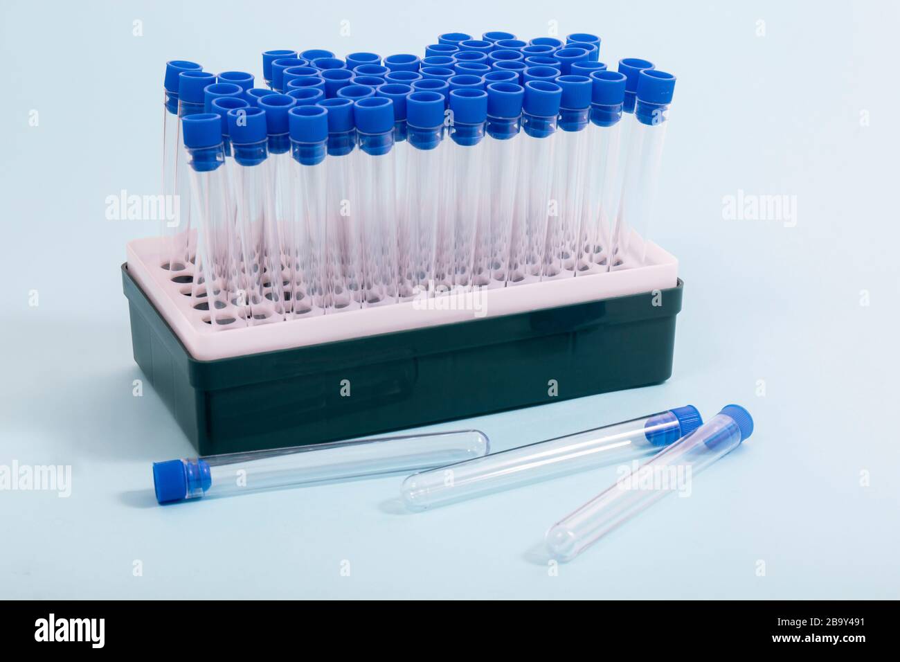 Vial rack filled with testing tubes isolated on blue background Stock ...