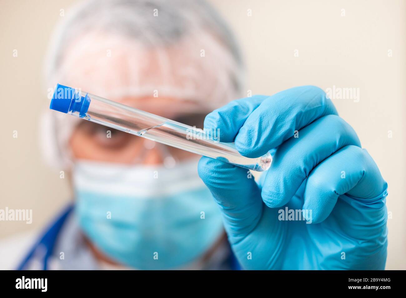 View of caucasian doctor with test tube on a white background Stock ...