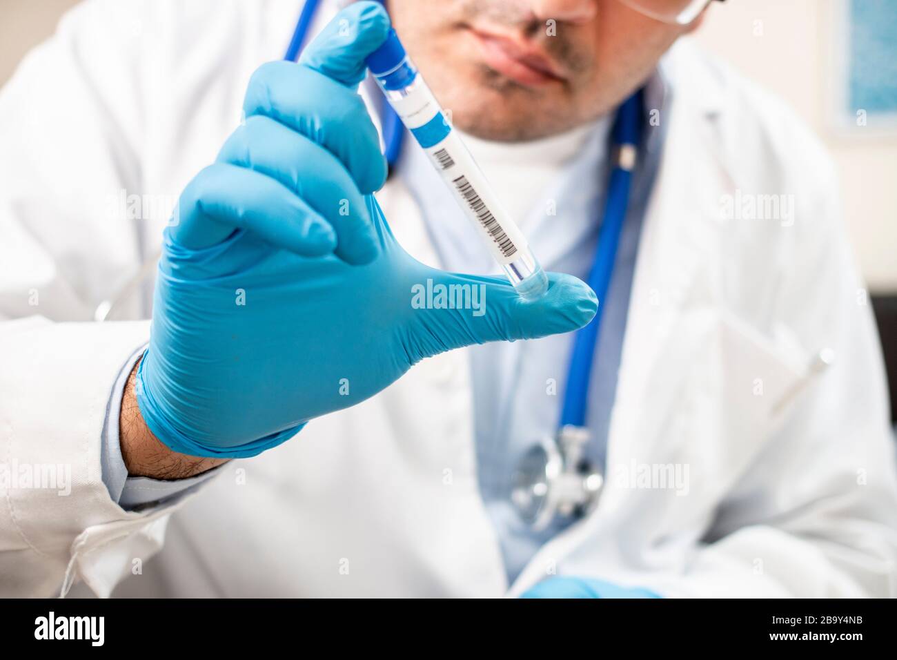 View of caucasian doctor with fictional test tube on a white background ...