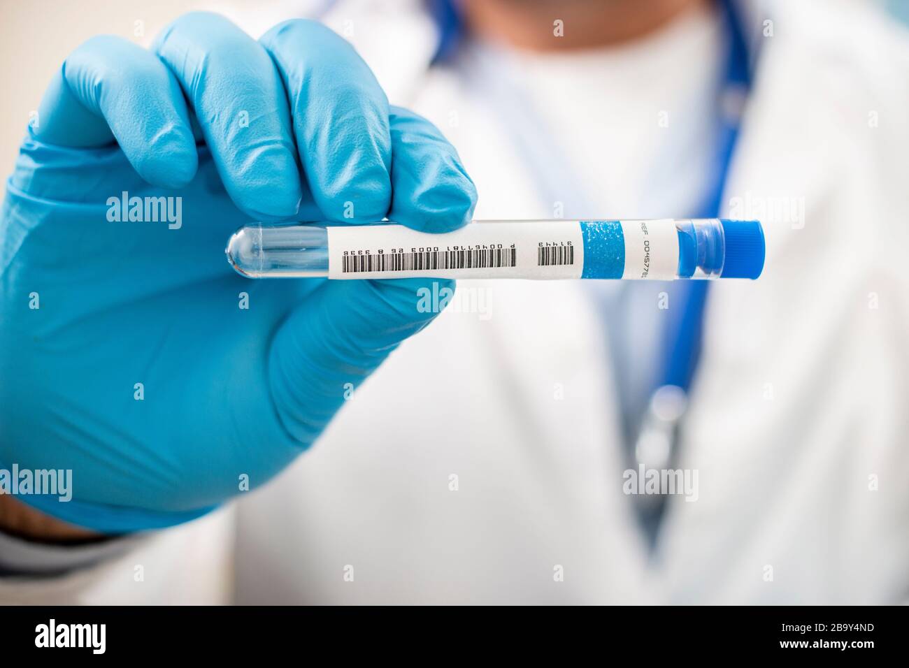 View of caucasian doctor with fictional test tube on a white background ...
