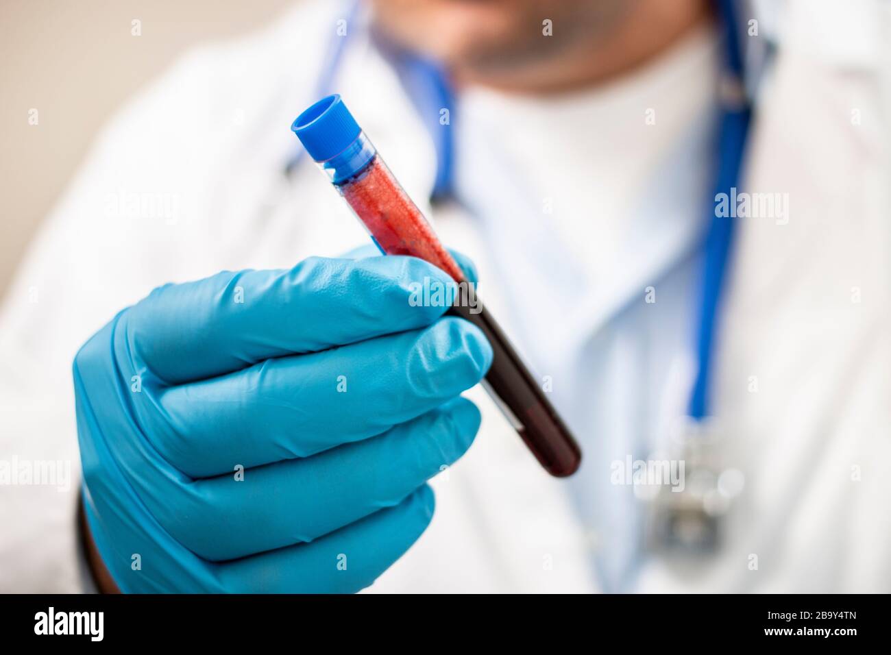 View of a doctor holding a fictional test tube blood sample, possibly ...