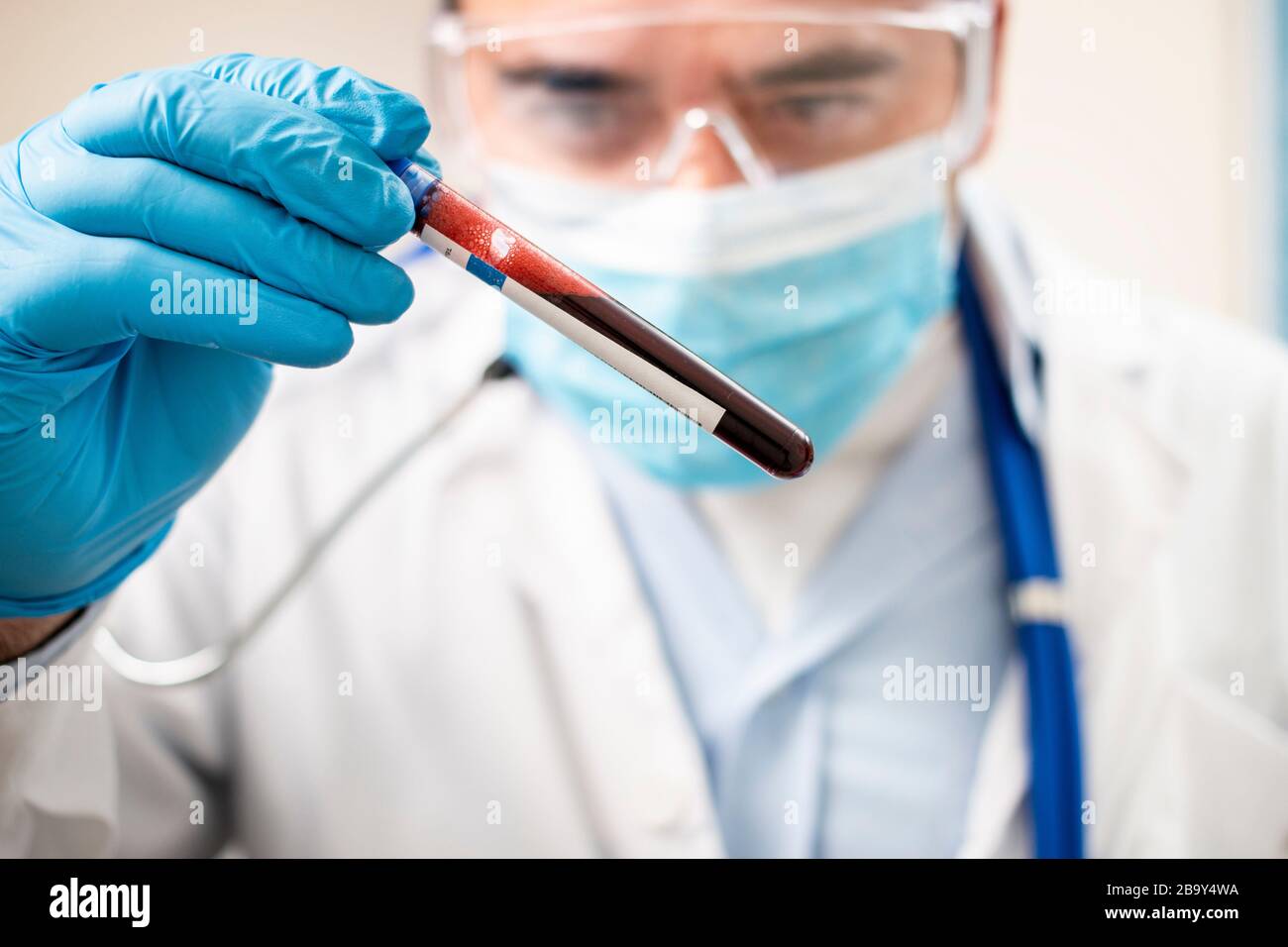 View of a doctor holding a fictional test tube blood sample, possibly ...