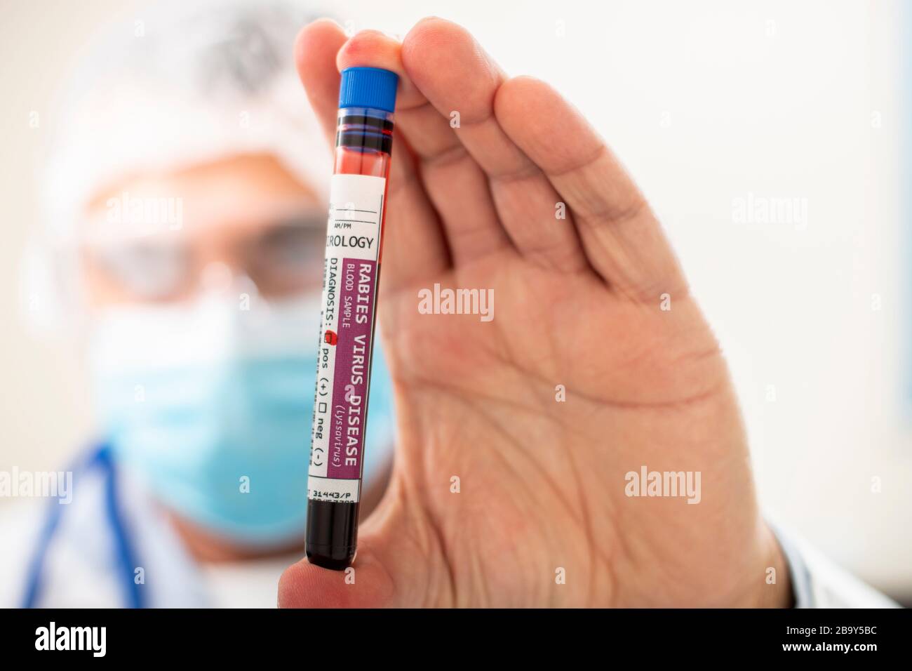 View of a doctor holding a fictional test tube blood sample, infected ...
