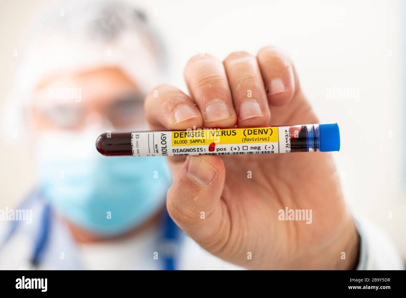 View of a doctor holding a fictional test tube blood sample, infected ...