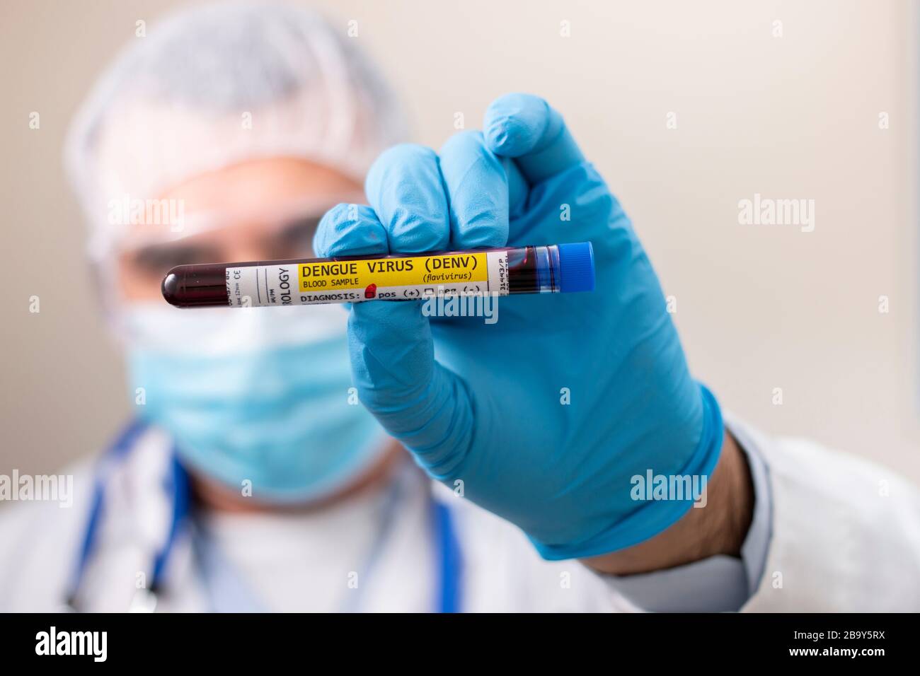 View of a doctor holding a fictional test tube blood sample, infected ...