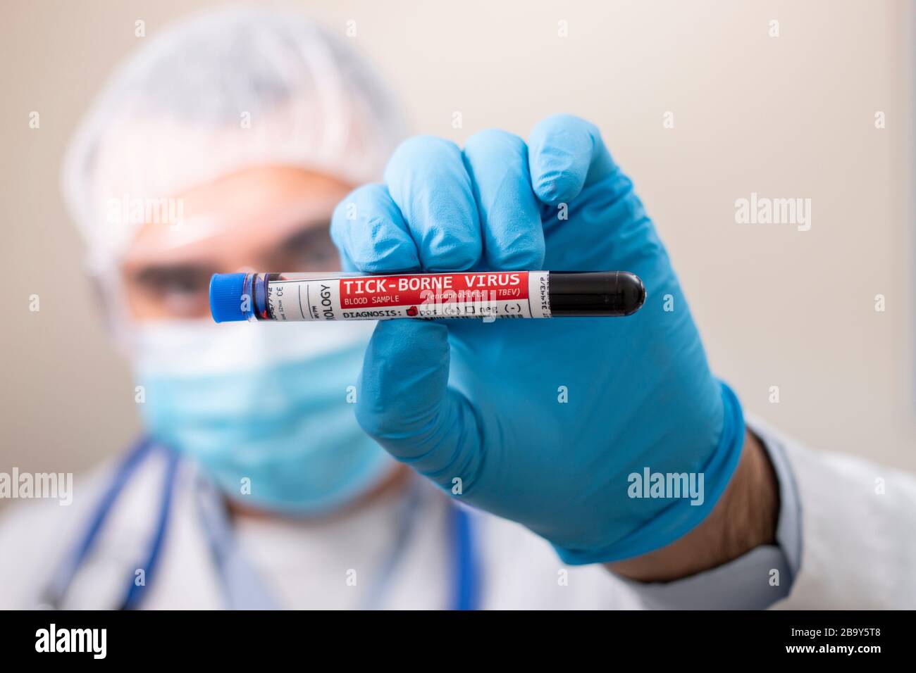 View of a doctor holding a fictional test tube blood sample, infected ...