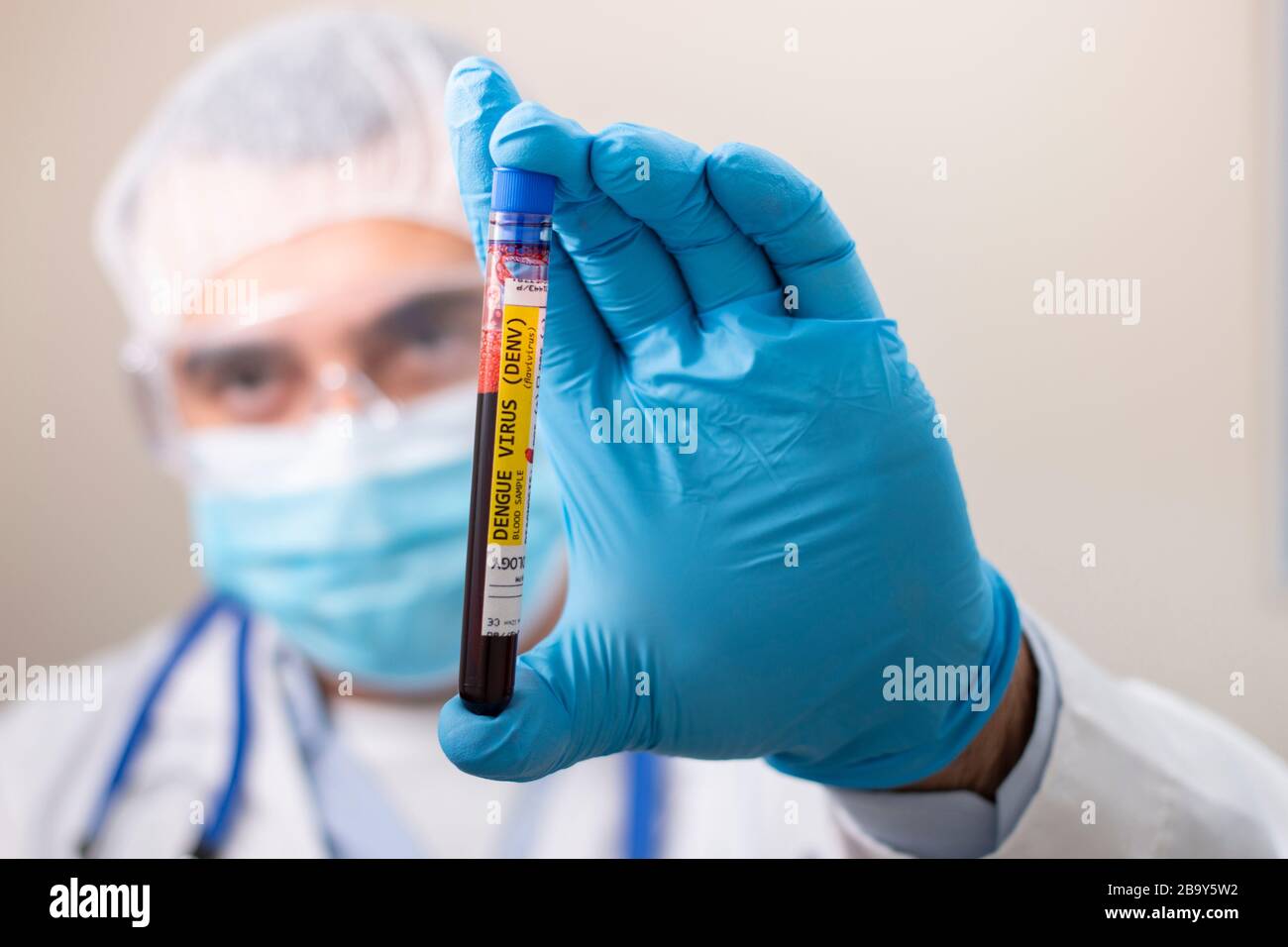View of a doctor holding a fictional test tube blood sample, infected ...