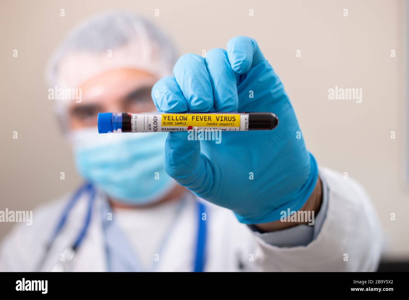 View of a doctor holding a fictional test tube blood sample, infected ...