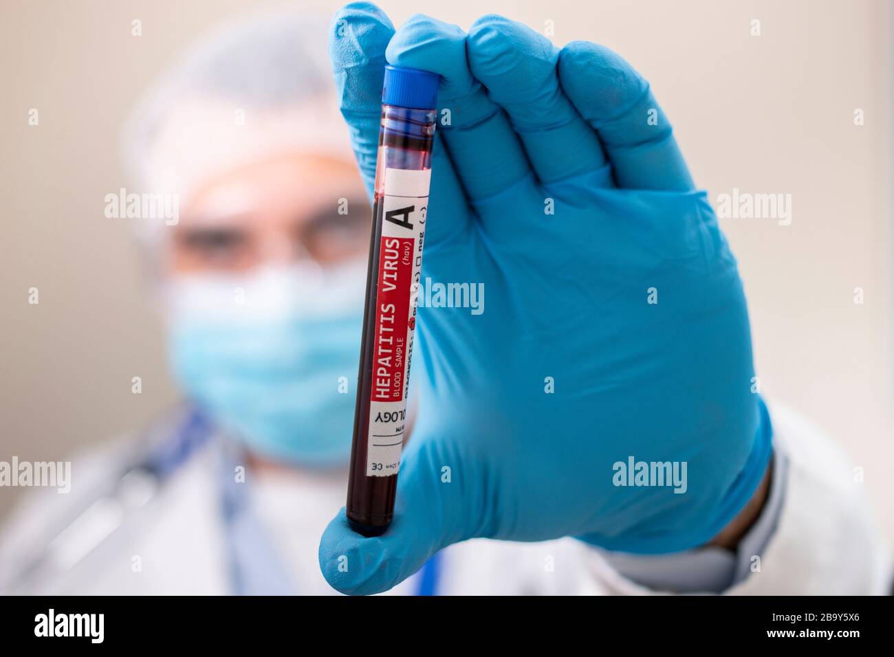 View of a doctor holding a fictional test tube blood sample, infected ...