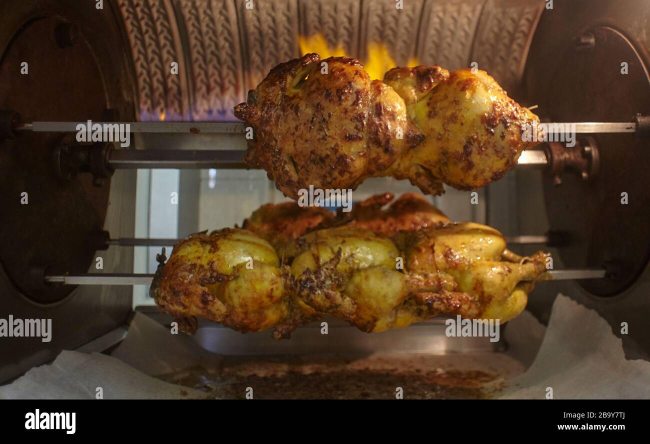 Chickens cooking in the rotisseries 5 Stock Photo - Alamy