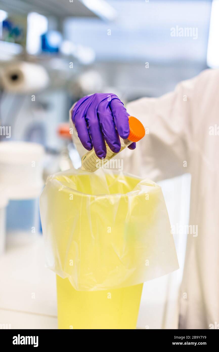 Close up hand dipping flask in special container Stock Photo - Alamy