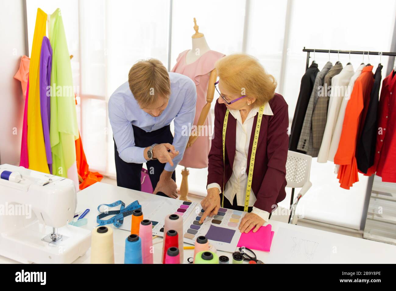 The female senior designer advises male customers to use the suit ...