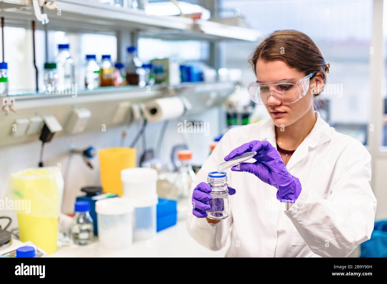 Girl in safety glasses prepare solution in lab Stock Photo - Alamy