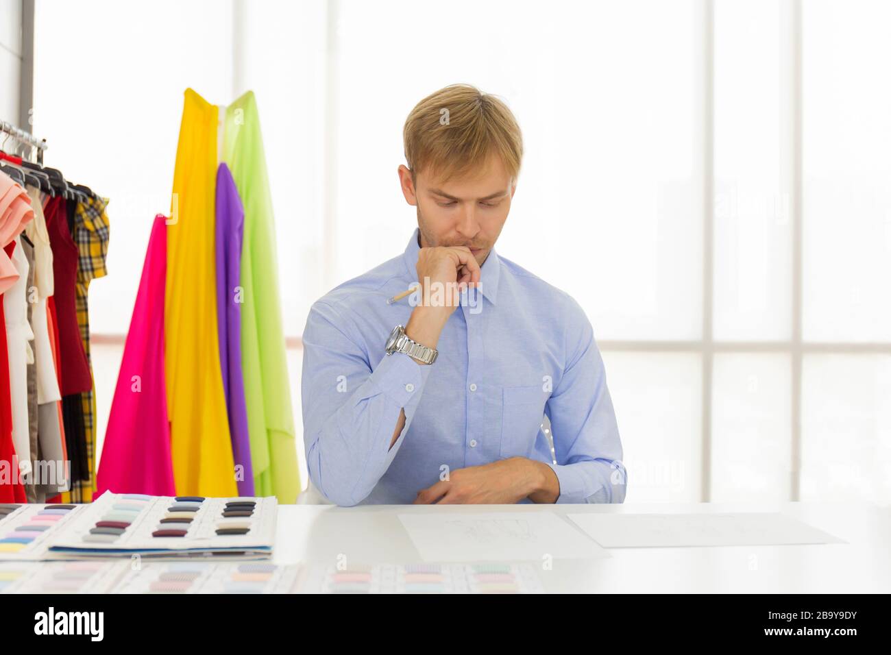 Male designers who are sketching on paper to design clothes Stock Photo ...