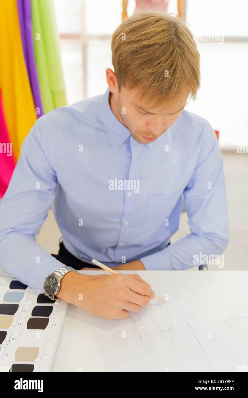 Male designers who are sketching on paper to design clothes Stock Photo ...