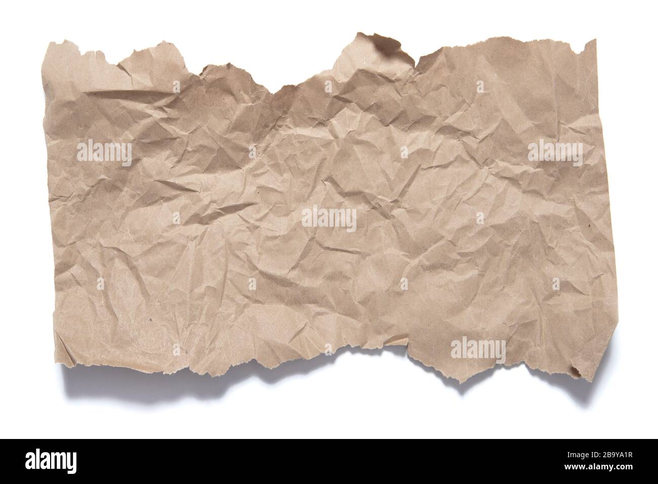 Fragment brown paper with torn edges and crumple traces. Object on ...