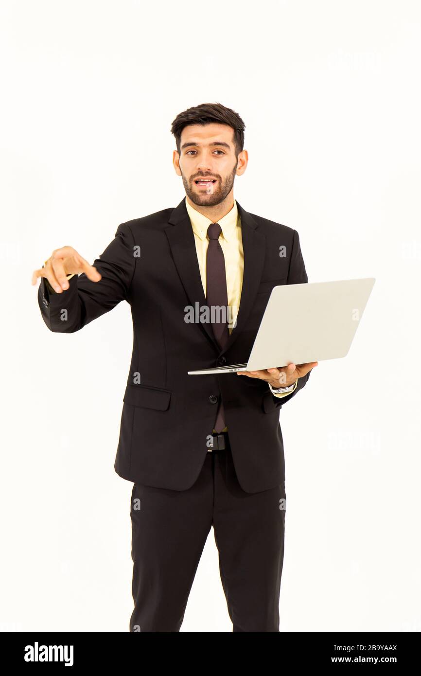 A handsome young man standing on a tablet isolated on white background ...