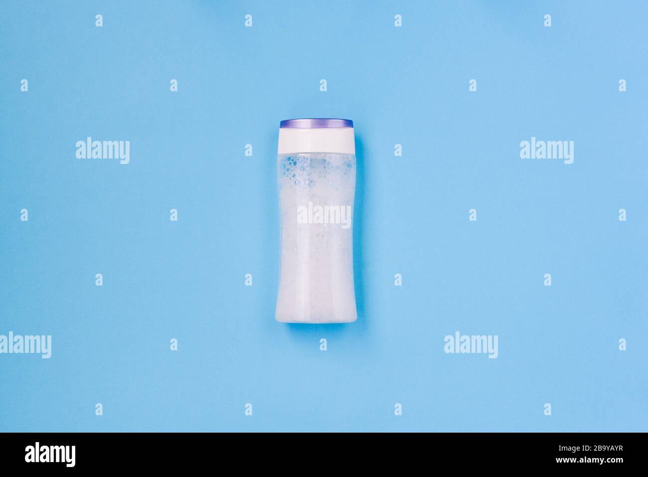 Plastic bottle with shampoo on a blue background. Cosmetic product for ...